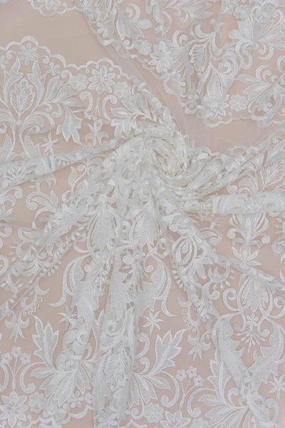 a background image of ivory-colored lace cloth. White lace on beige ...