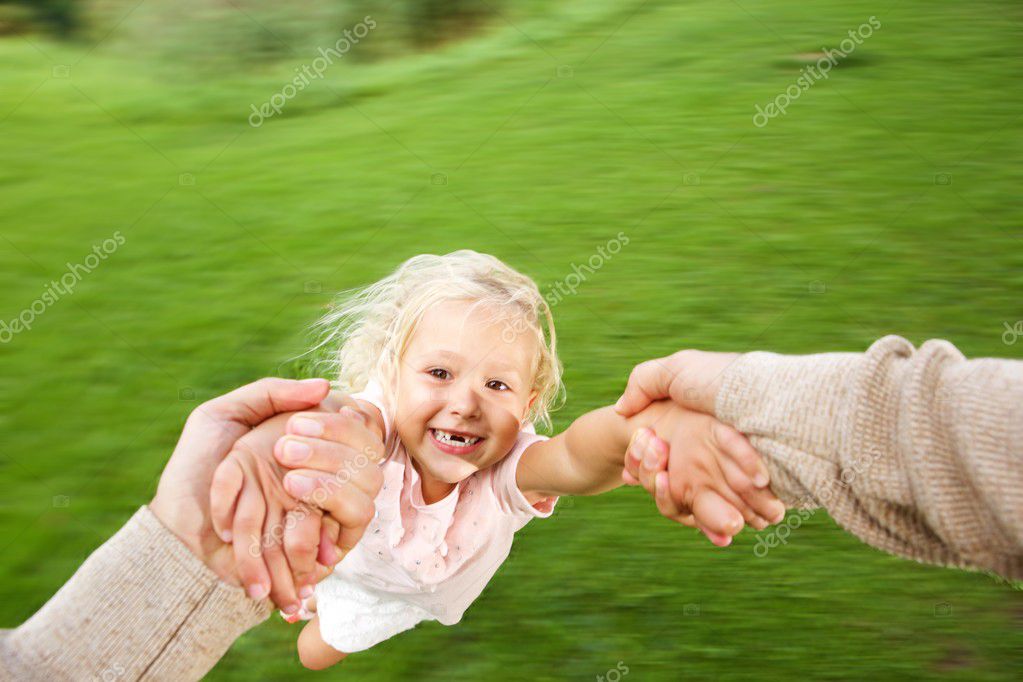 Girl being spun in circles at park Stock Photo by ©mimagephotos 127428828