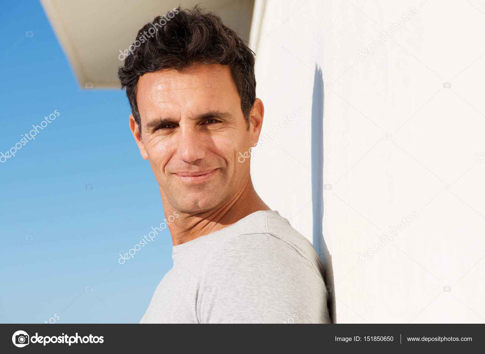 Handsome guy leaning against wall outside Stock Photo by ©mimagephotos ...