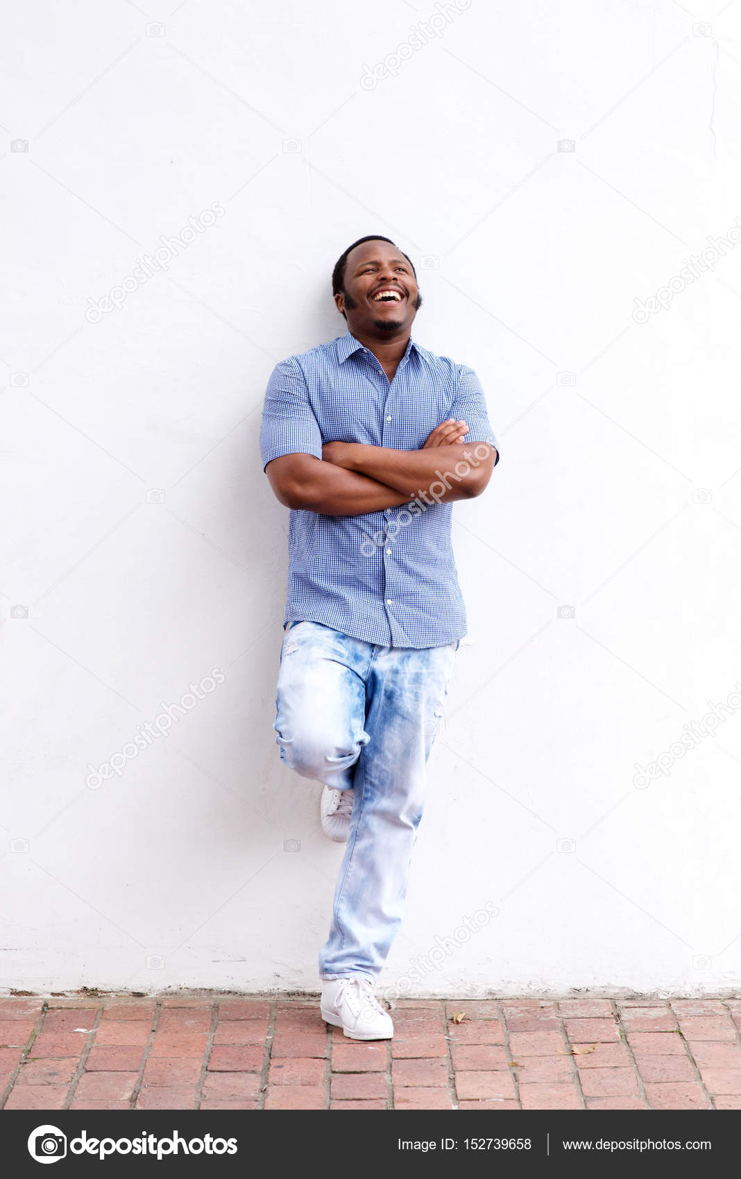 Man leaning against wall Stock Photo by ©mimagephotos 152739658 Man leaning against wall Stock Photo by ©mimagephotos 152739658
