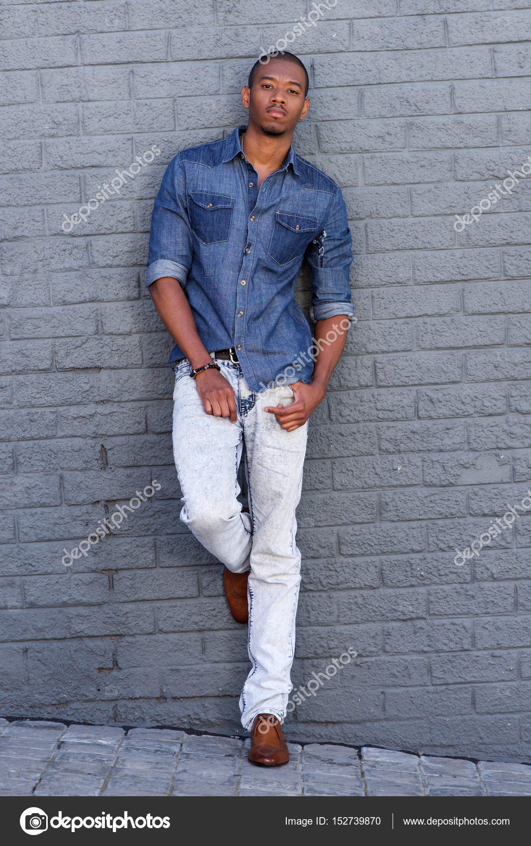 Guy leaning against gray wall Stock Photo by ©mimagephotos 152739870 Guy leaning against gray wall Stock Photo by ©mimagephotos 152739870
