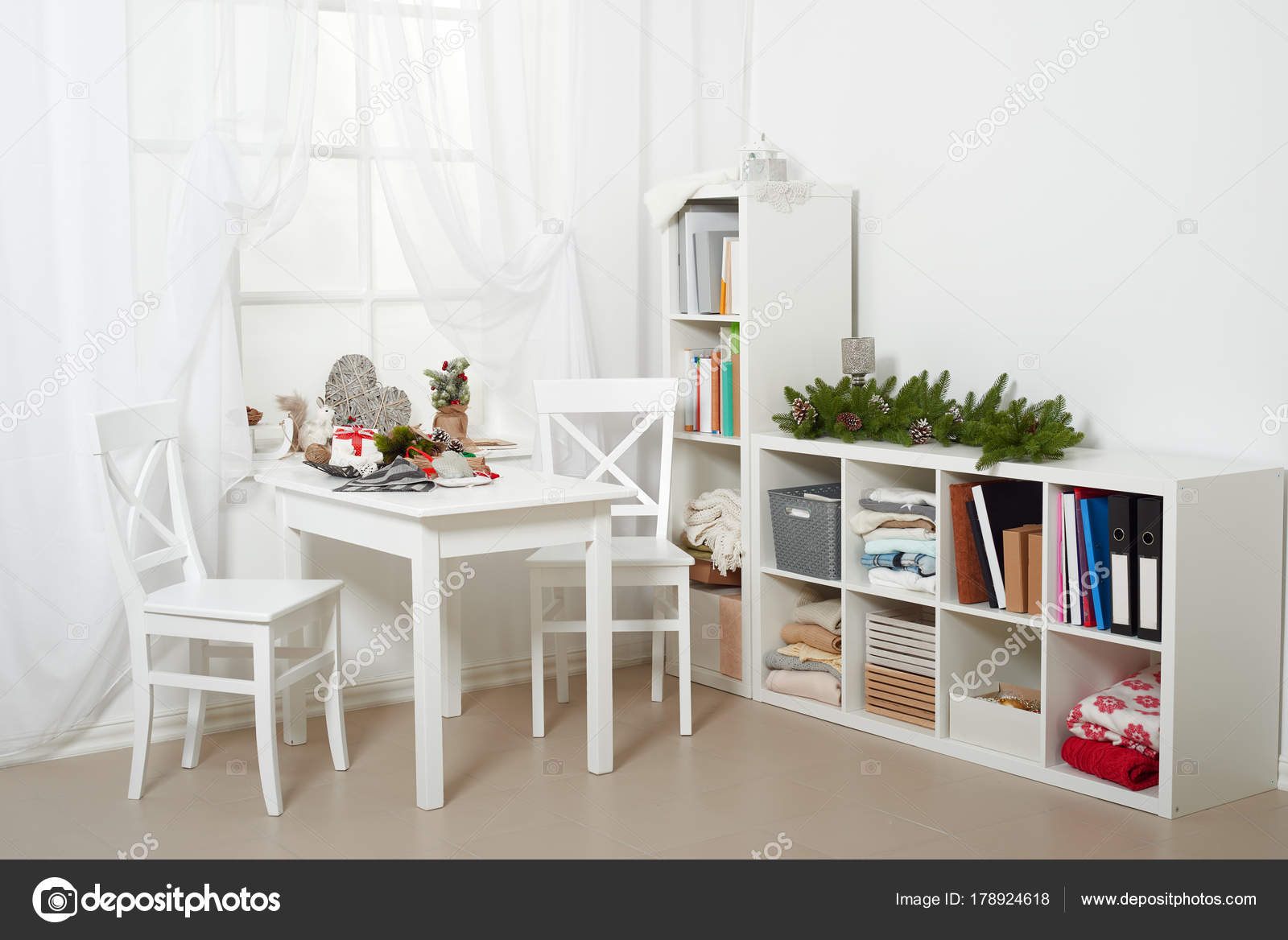 White room interior with christmas decoration, window, table and chair ...