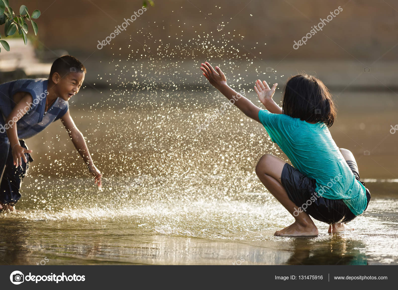 Kids playing with water – Stock Editorial Photo © smithore #131475916
