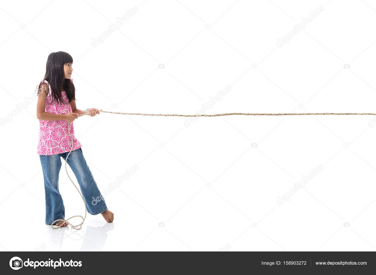 Conceptual Asian girl pulling on white background Stock Photo by ...