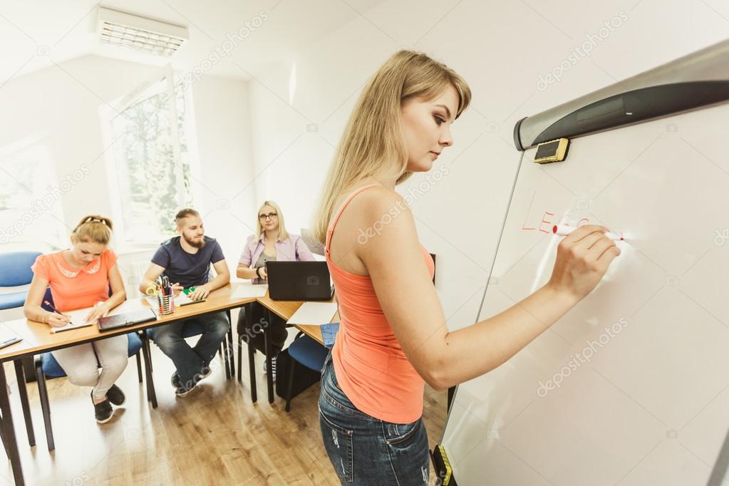 Students in classroom learning english Stock Photo by ©Voyagerix 125960972