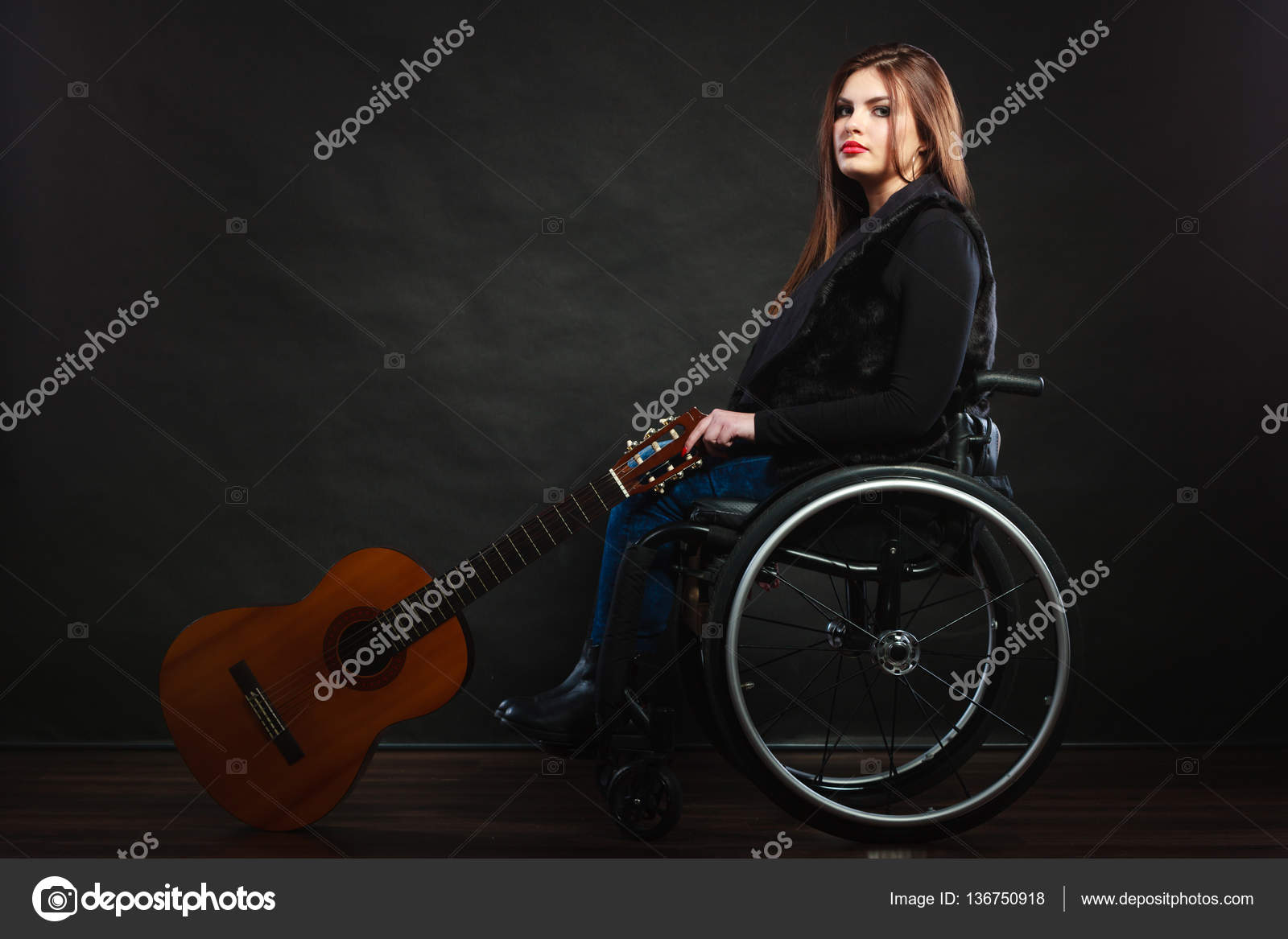Sad disabled girl with guitar. Stock Photo by ©Voyagerix 136750918