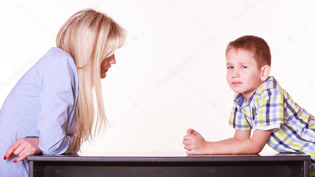 Madre e hijo hablan y discuten se sientan a la mesa. 2024