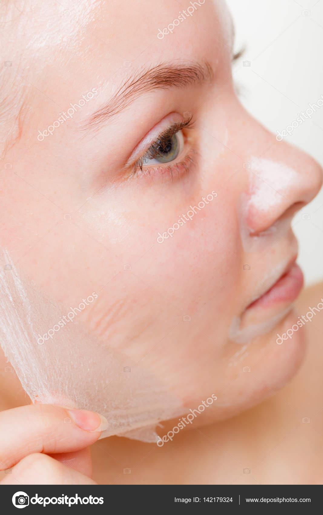 Woman removing facial peel off mask closeup Stock Photo by ©Voyagerix ...