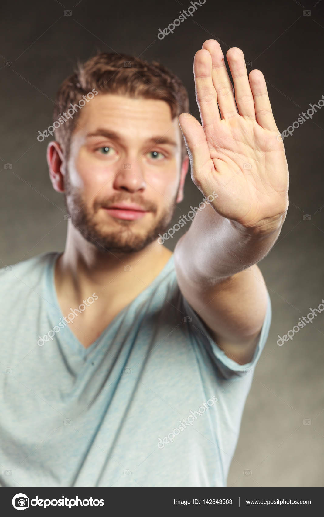 Handsome man showing stop sign gesture. Stock Photo by ©Voyagerix 142843563