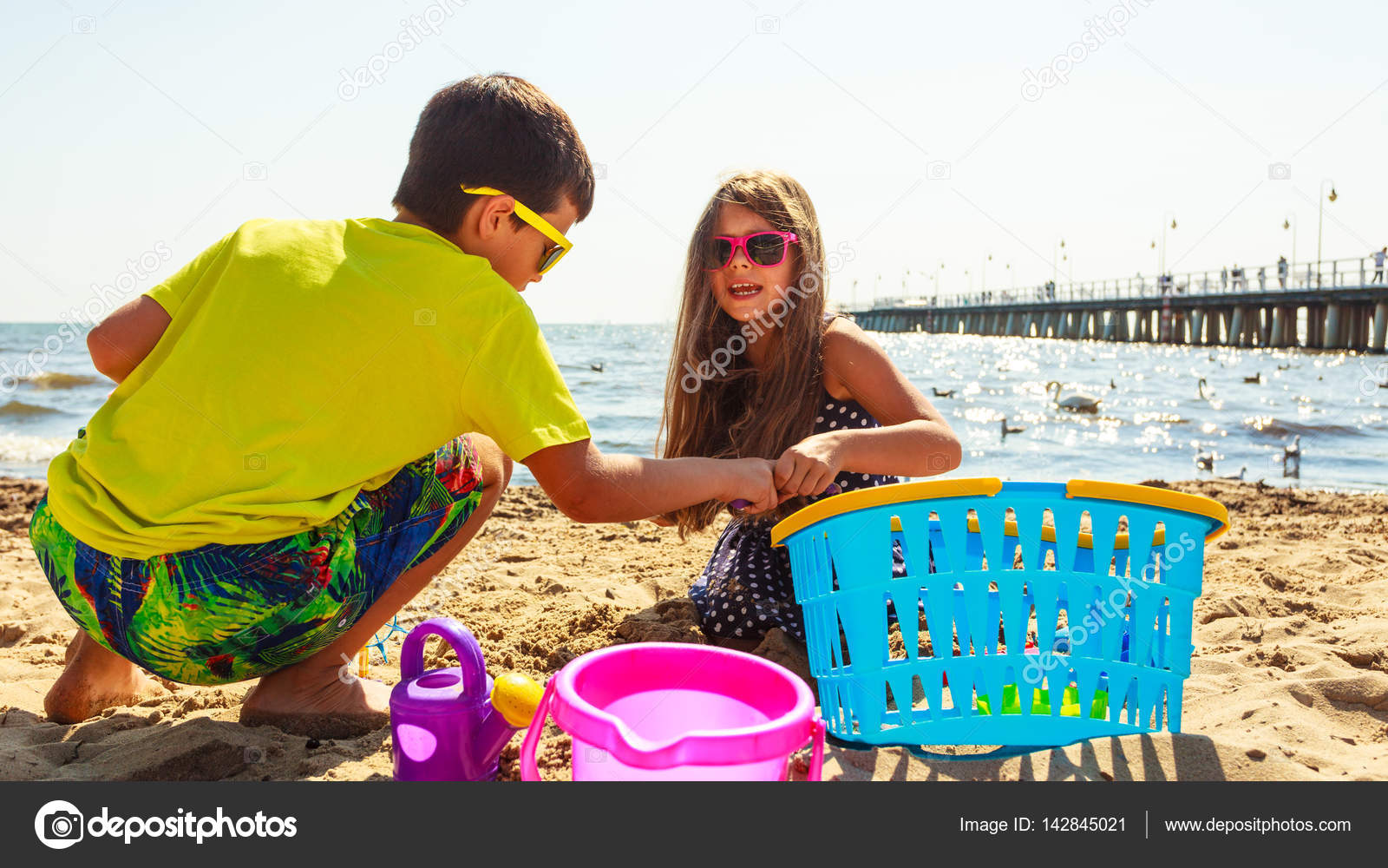 Kids playing outdoor on beach. Stock Photo by ©Voyagerix 142845021