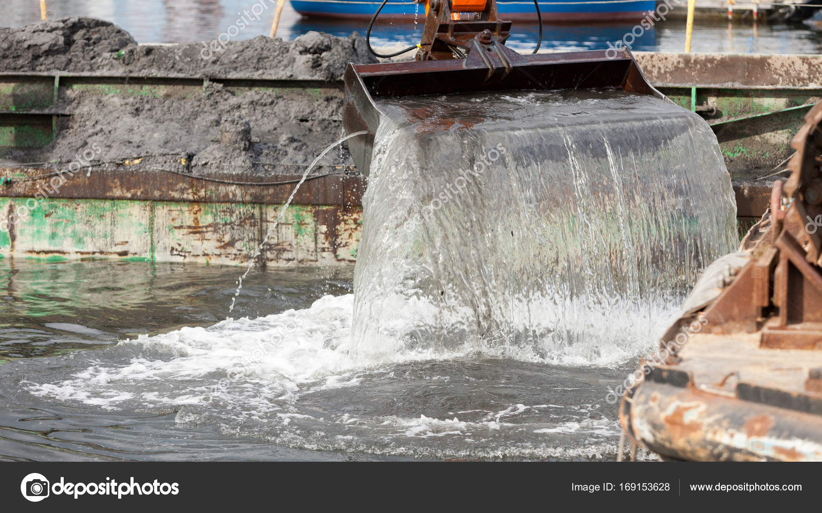 Excavator shovel digging in sand from water — Stock Photo © Voyagerix ...
