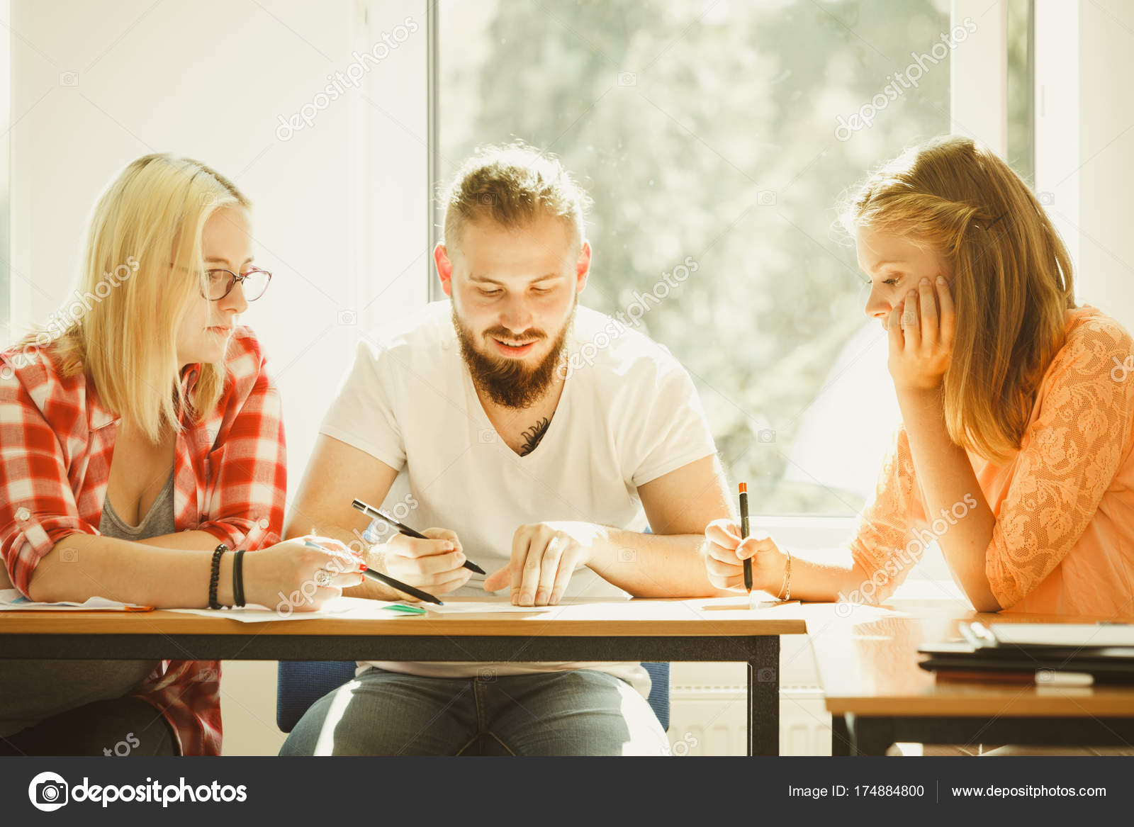 Group of students in class Stock Photo by ©Voyagerix 174884800