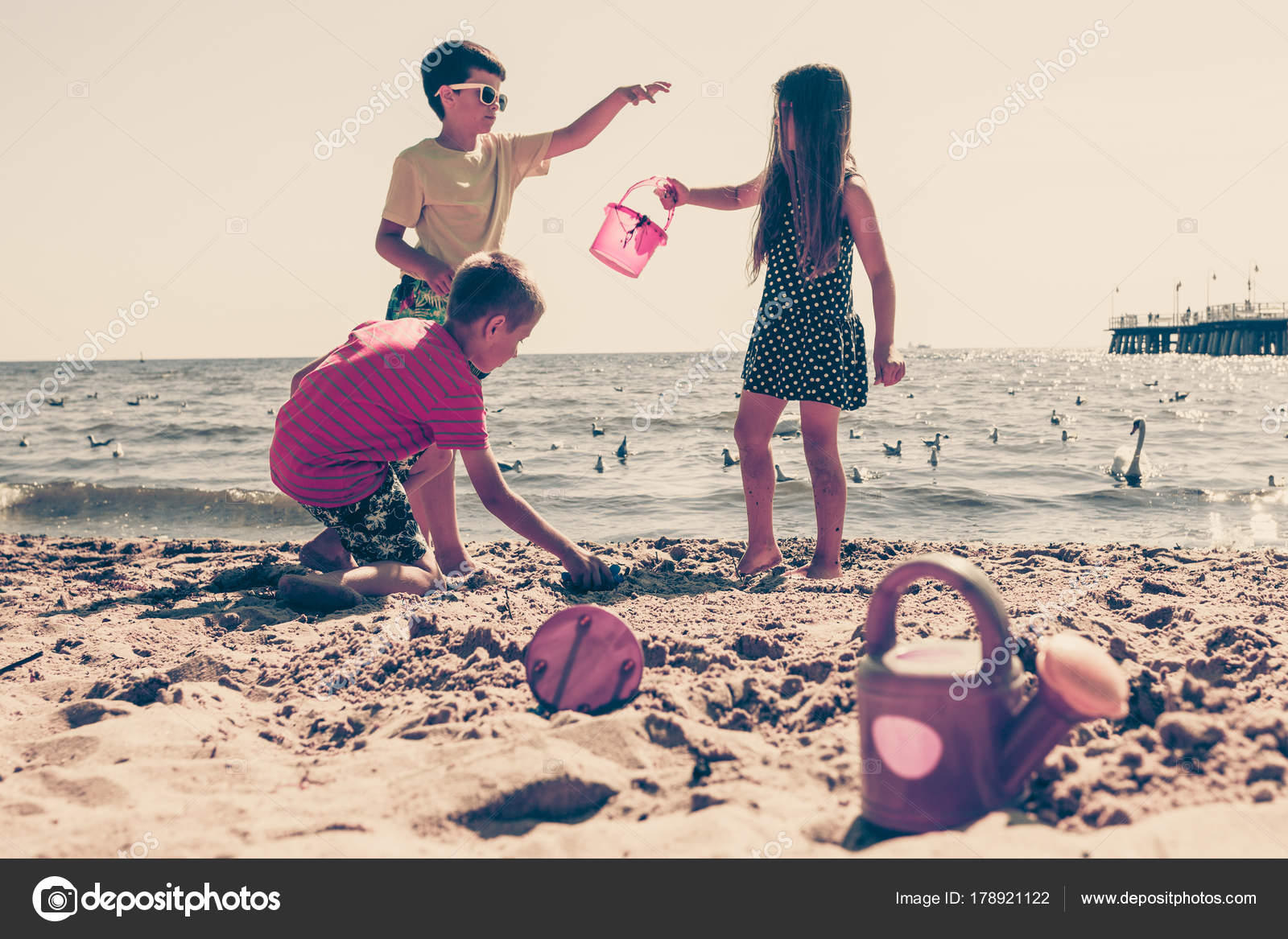 Kids playing outdoor on beach. Stock Photo by ©Voyagerix 178921122