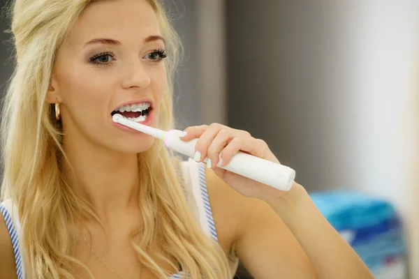 Playful Young Woman Holding Toothbrush in Bathroom Stock Photo by ...