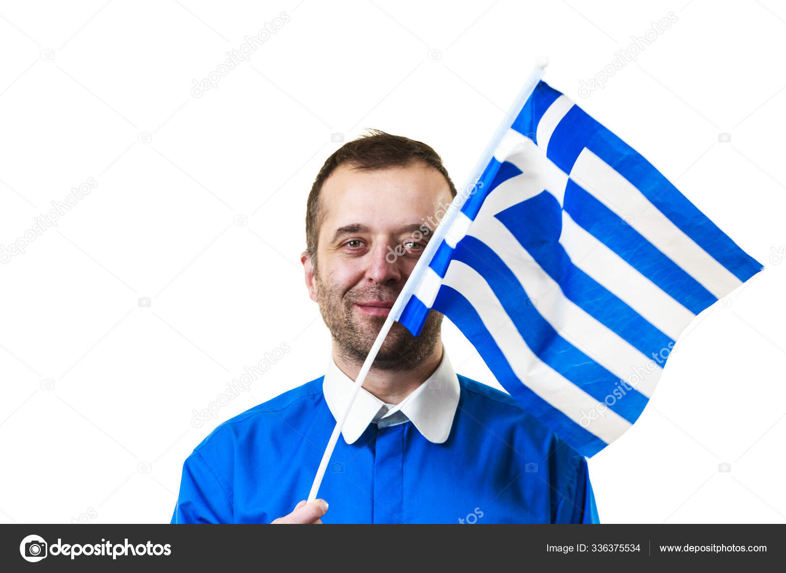 Happy man holding Greek flag Stock Photo by ©Voyagerix 336375534