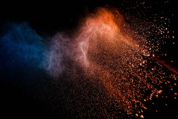 Orange blue powder explosion on black background.Orange blue color dust ...
