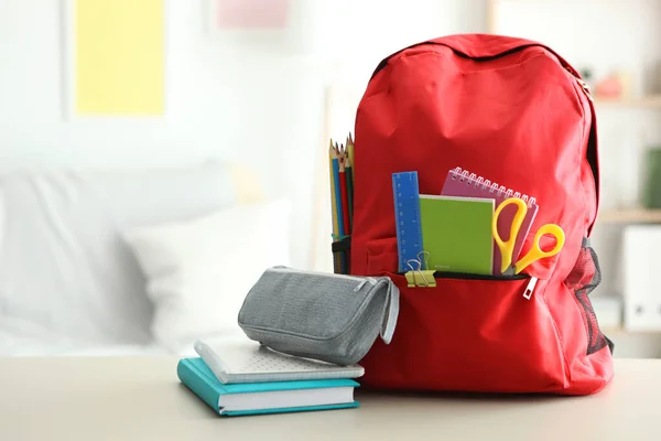 school backpack and stationery in a bright room. Preparing for school ...