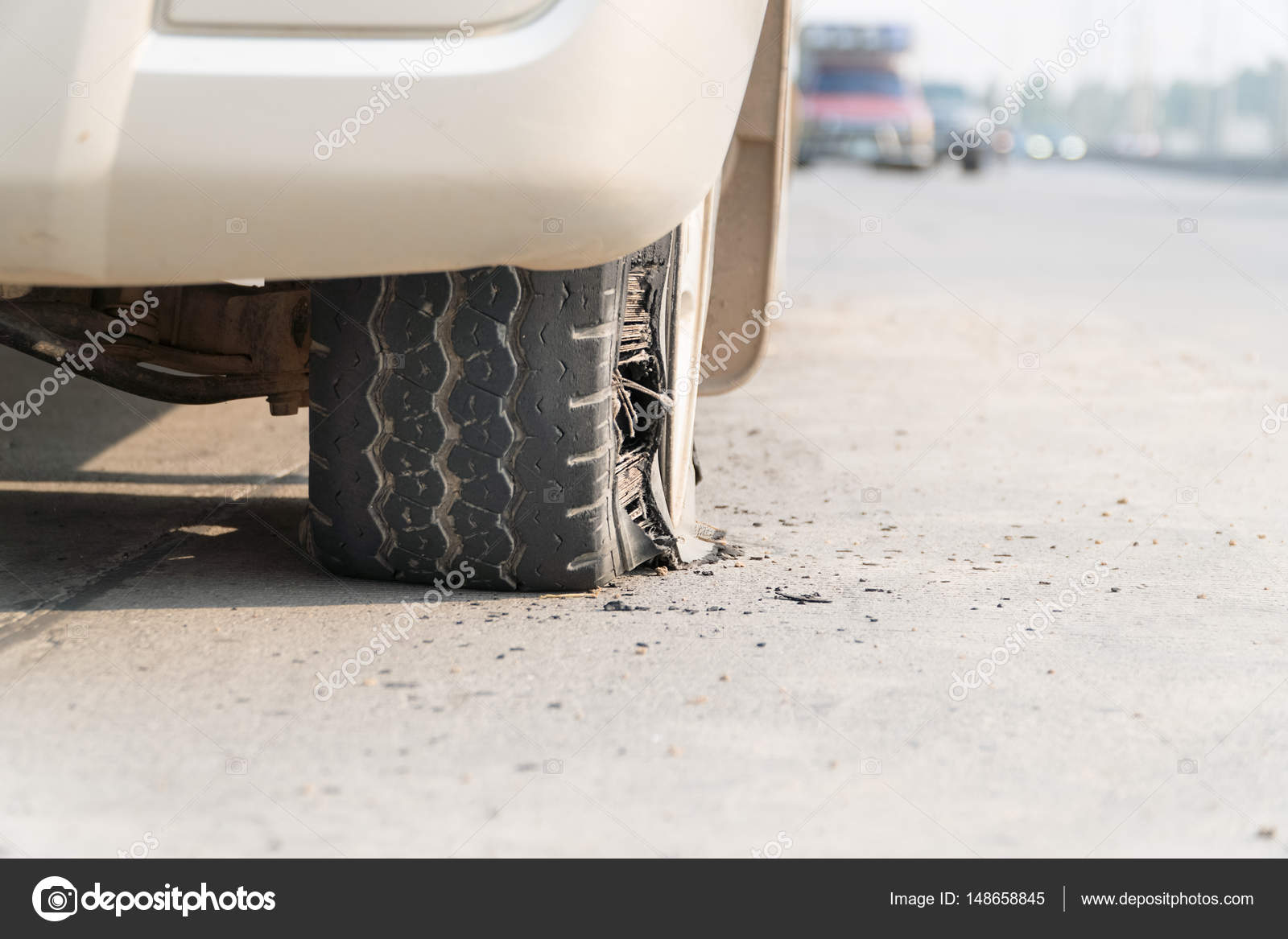 Burst tire on the road Stock Photo by ©toa55 148658845