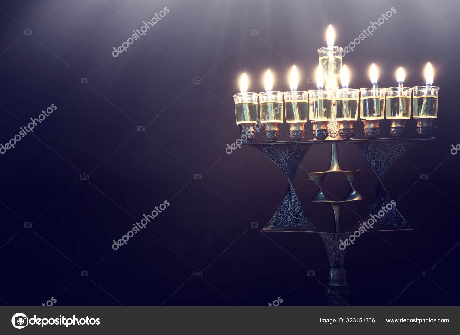 Religion image of jewish holiday Hanukkah background with bronze david ...
