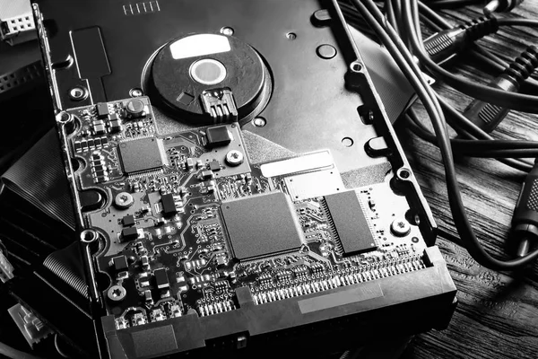 Hard drive on the table in the workshop. Computer hard drive. Chips and ...