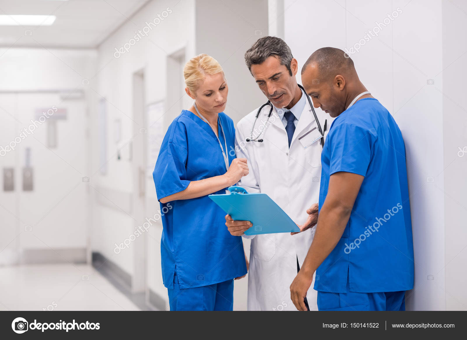 Multicultural Medical Team Having Meeting In Hospital Corridor Stock