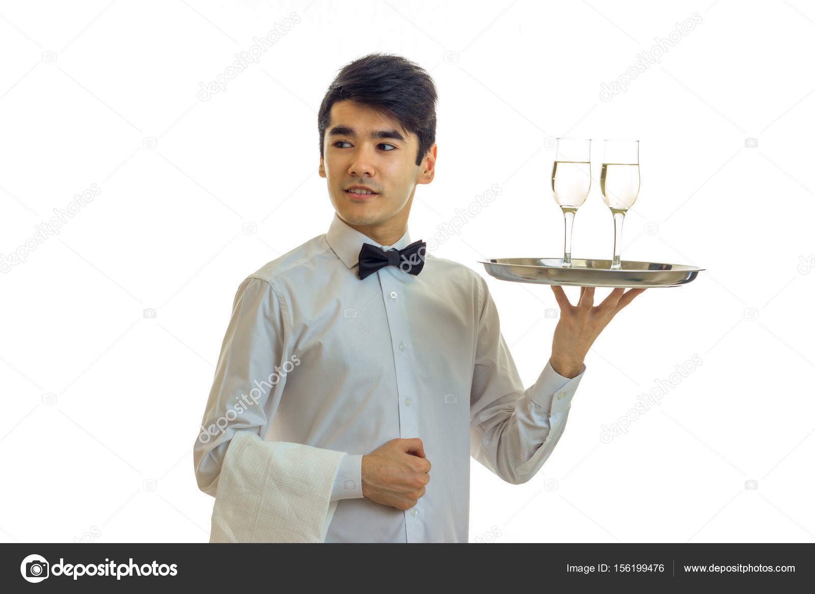 Attractive young waiter in a shirt raised in hand a tray with glasses ...