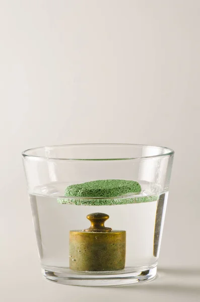 Physics. Heavy and light objects in water. Stock Photo by ©pathastings ...