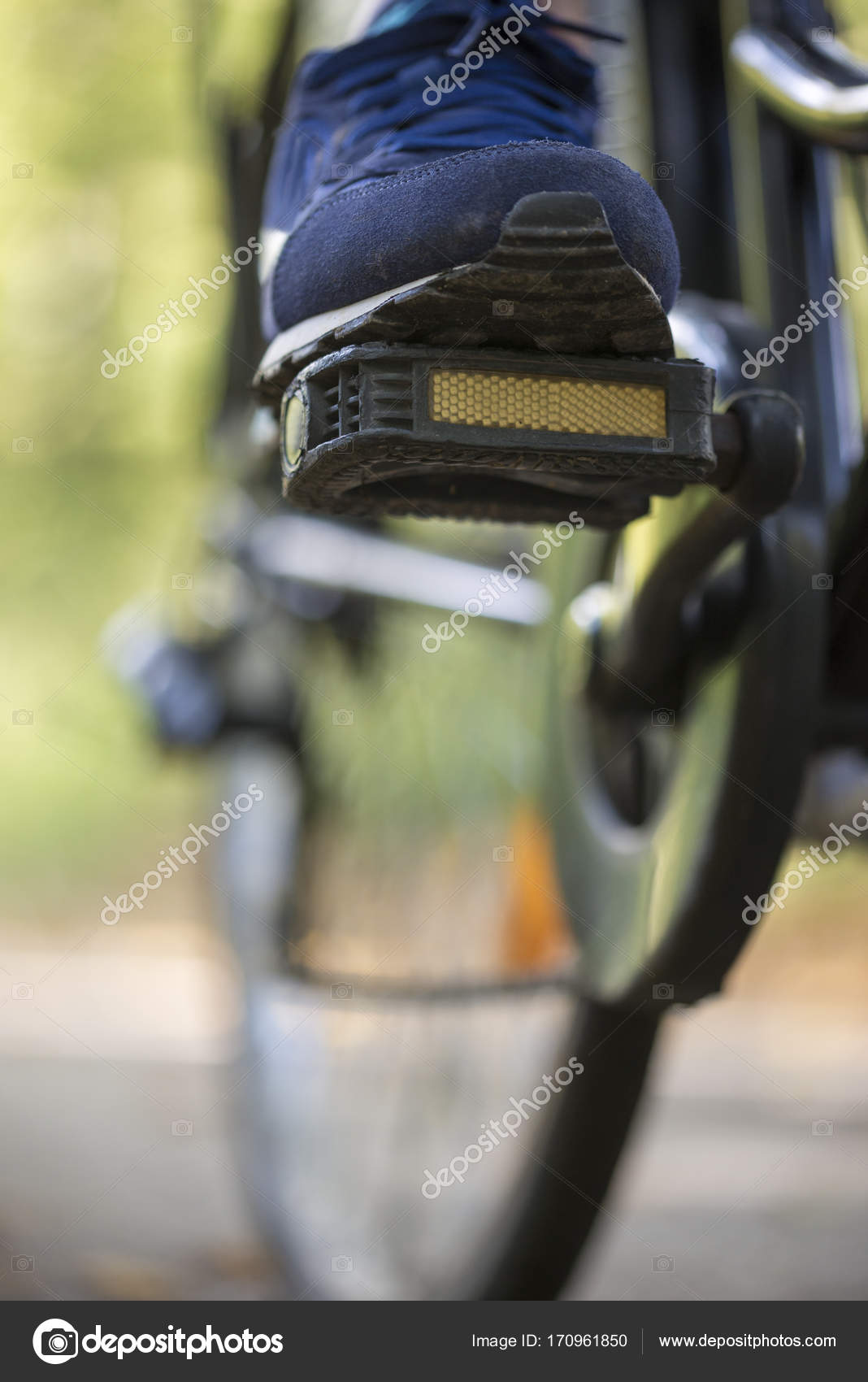 Person riding a bicycle in a low angle view of the foot — Stock Photo ...