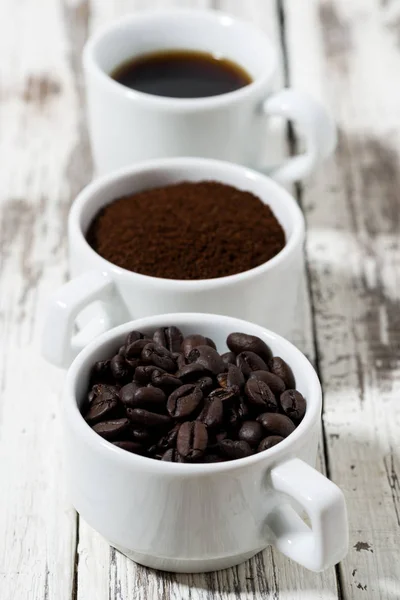 Three types of coffee - ground, grain and beverage in cups - Stock ...