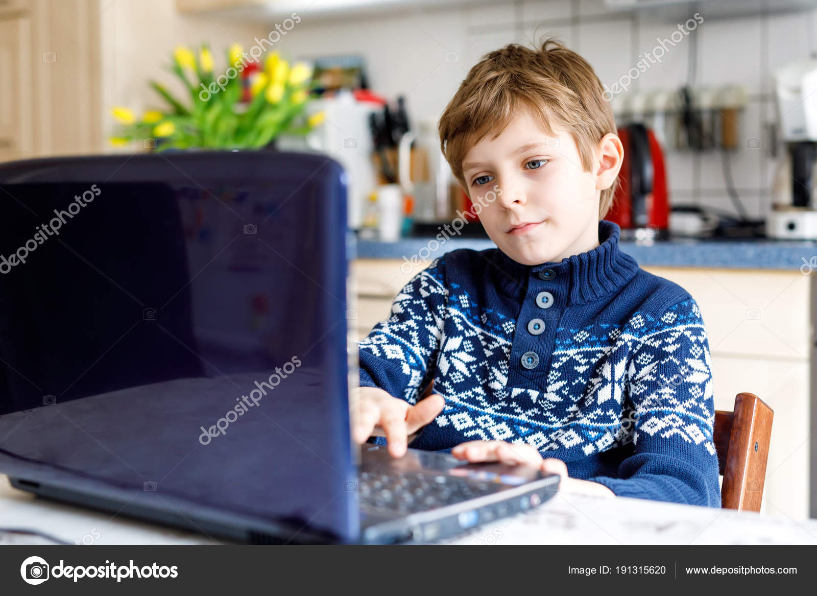 Little school kid boy making school homework on computer. Child having ...