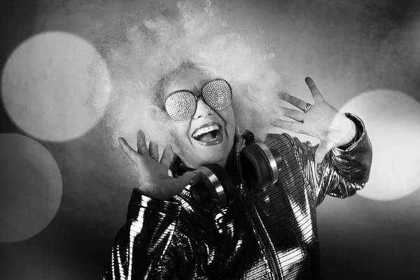 Grandma DJ partying in a disco setting Stock Photo by ©dubassy 170919514
