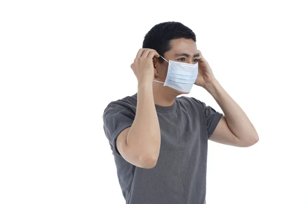 Asian young man in flu mask against with a corona virus pandemic, or ...