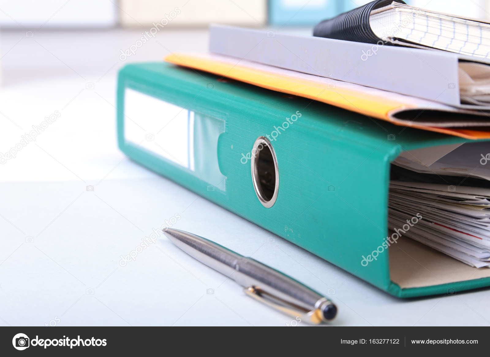 Folder file, note and pen on the desk. blurred background. Stock Photo ...