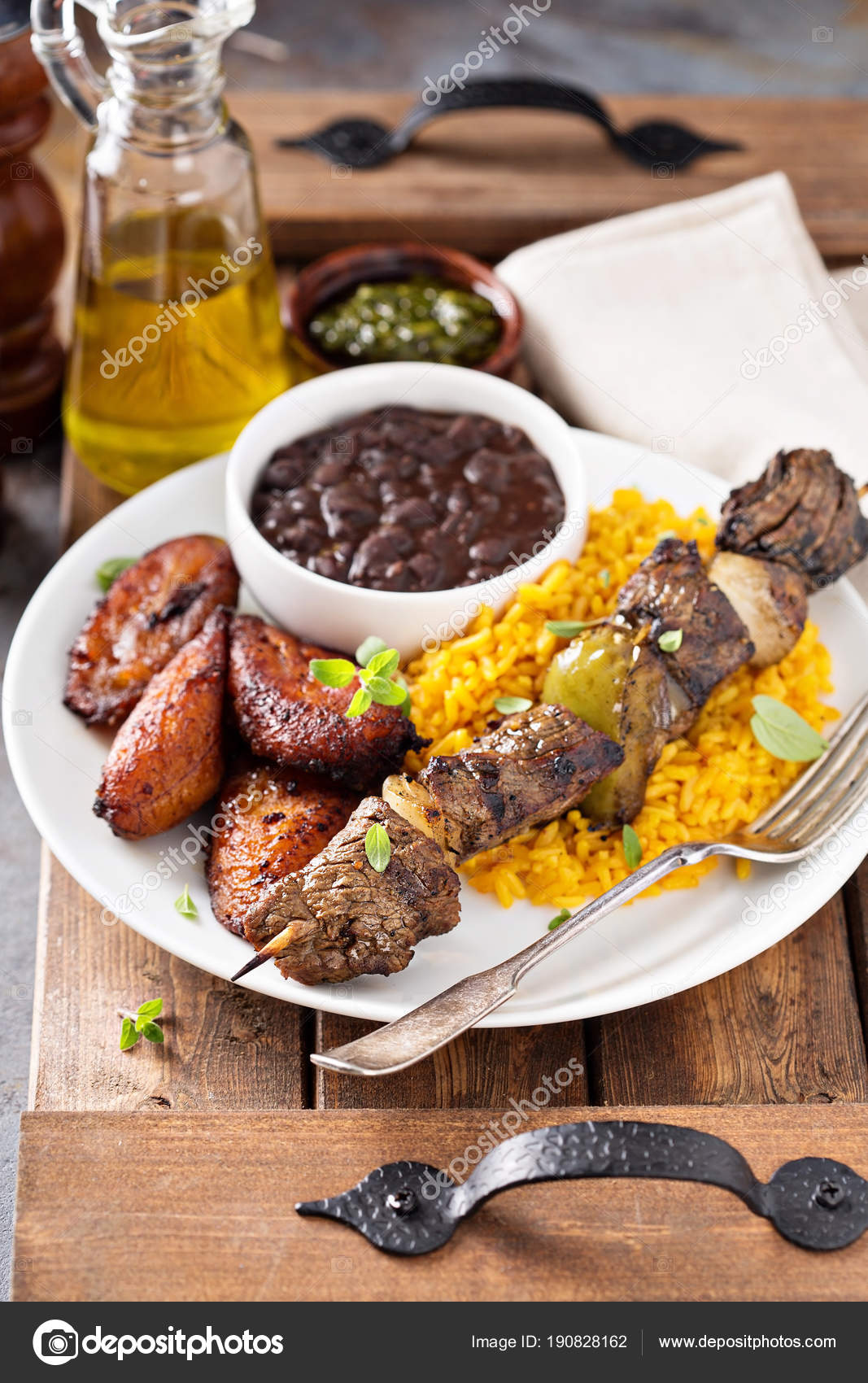 Beef kebab with rice, beans and fried plantains Stock Photo by ...