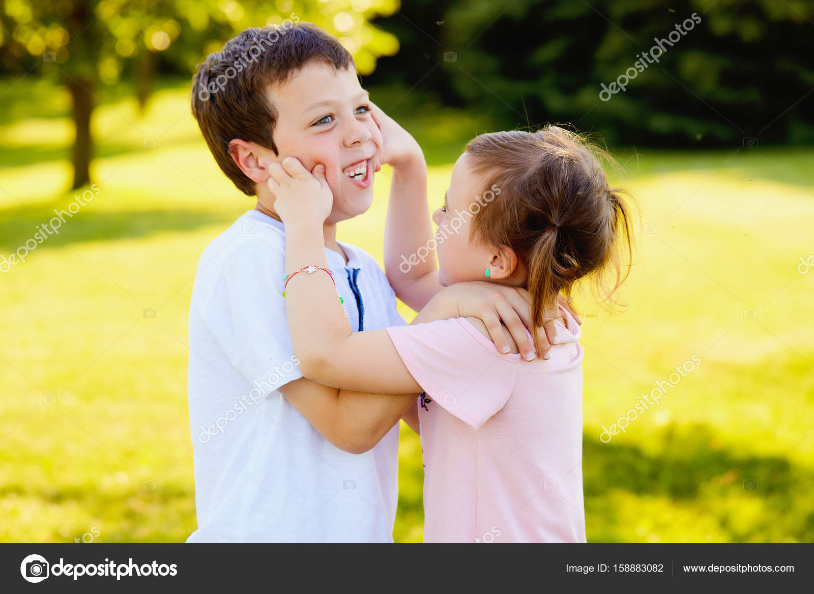 Naughty little girl pinching cheeks of her brother — Stock Photo ... Naughty little girl pinching cheeks of her brother — Stock Photo ...