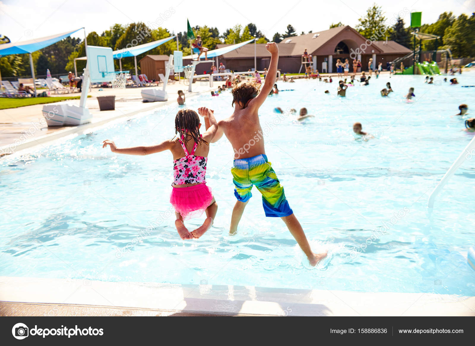 Excited children jumping in pool holding hands — Stock Photo ...
