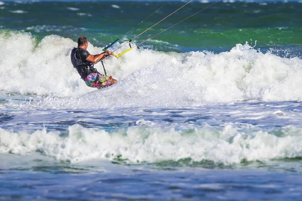 Young atletic man riding kite surf on a sea - Stock Image - Everypixel