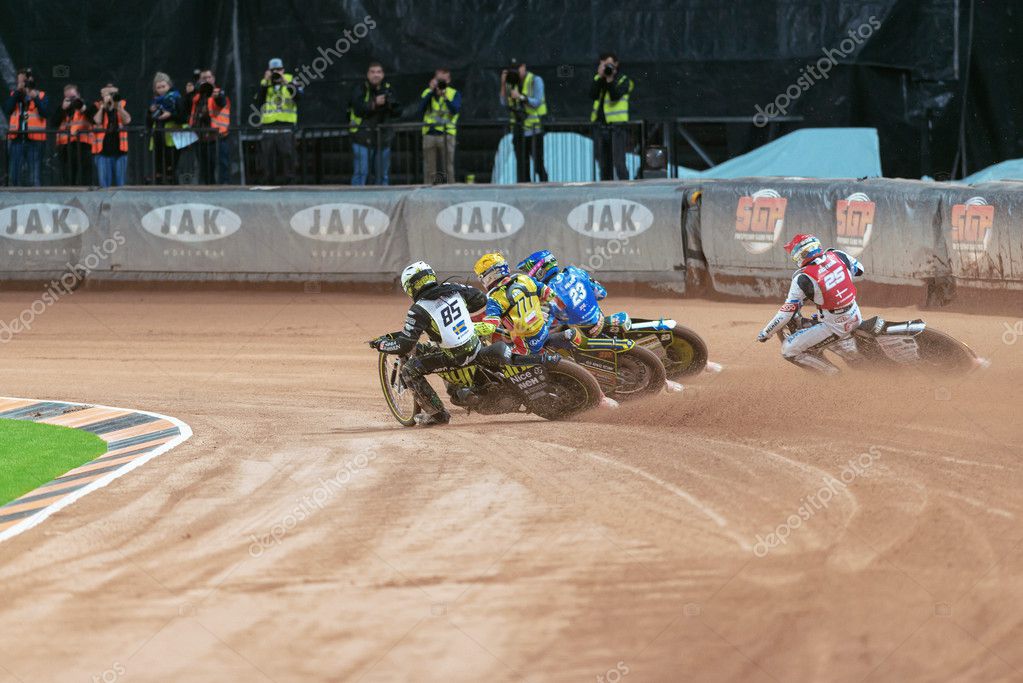 Four speedway riders into a curve at Stockholm FIM Speedway Gran ...