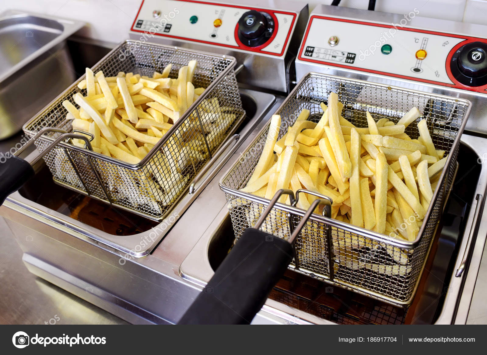 Crispy golden potato chips draining on a fryer — Stock Photo ...