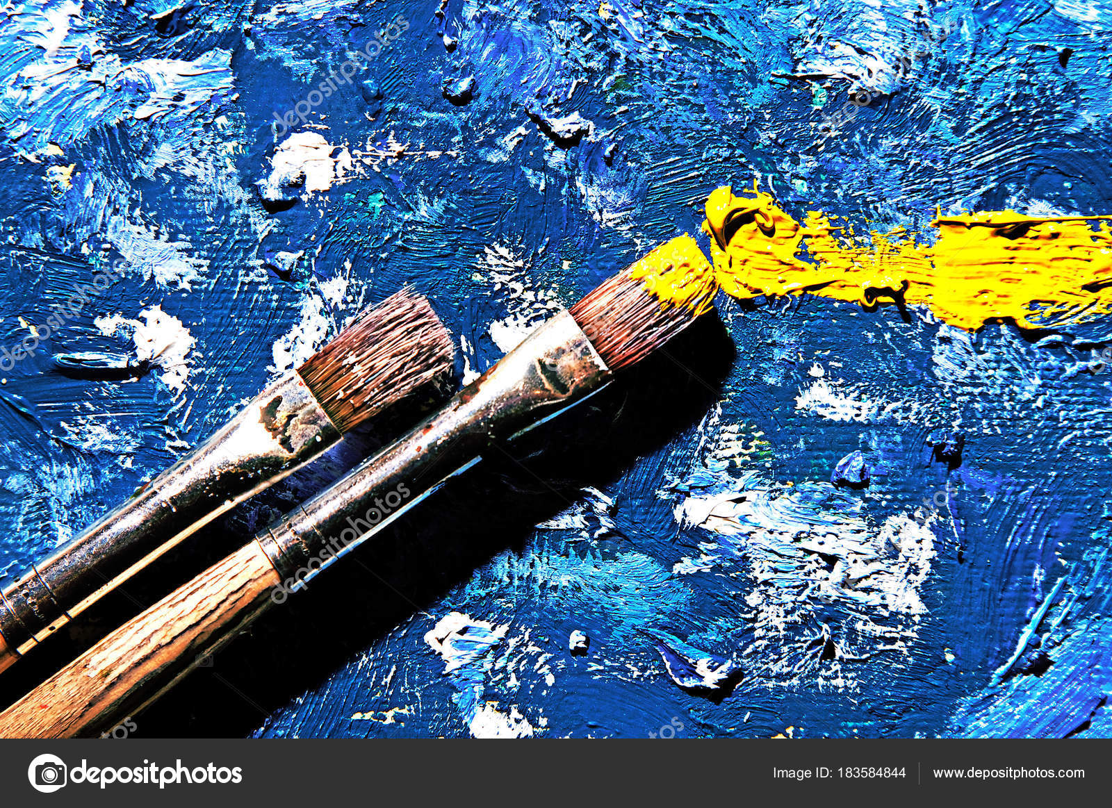 Two lying brushes on canvas painted with paint Stock Photo by ©demenyuk ...