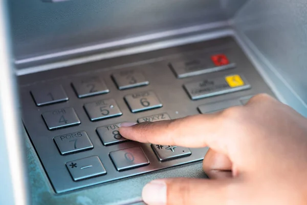 Close up hand enter password at ATM. Stock Photo by ©ichzigo 252065564