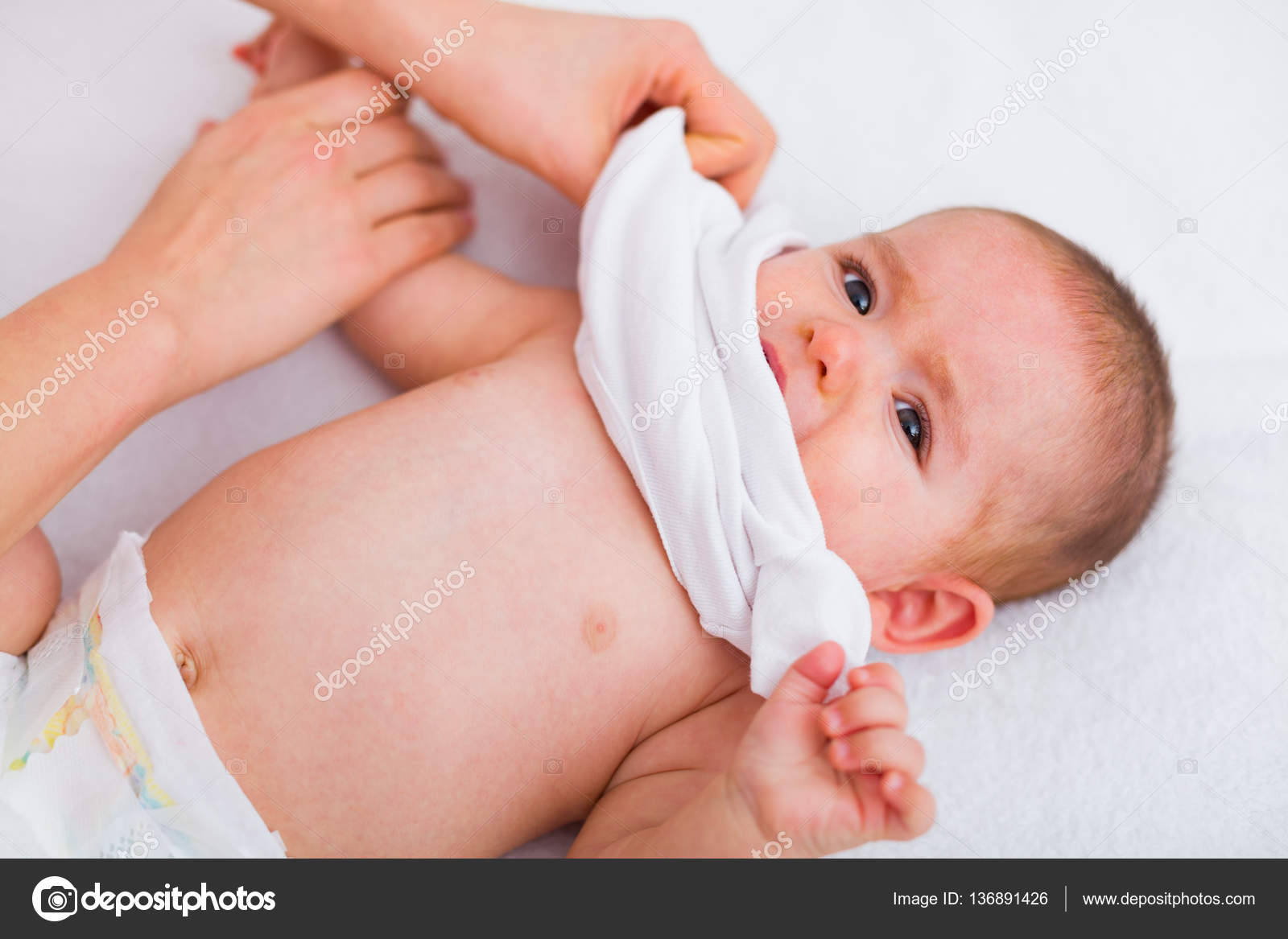 Mother changing kid clothes Stock Photo by ©Lighthunter 136891426