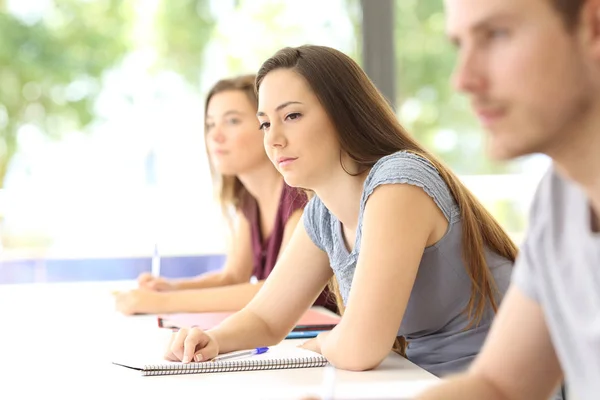 Distracted student in a classroom - Stock Image - Everypixel