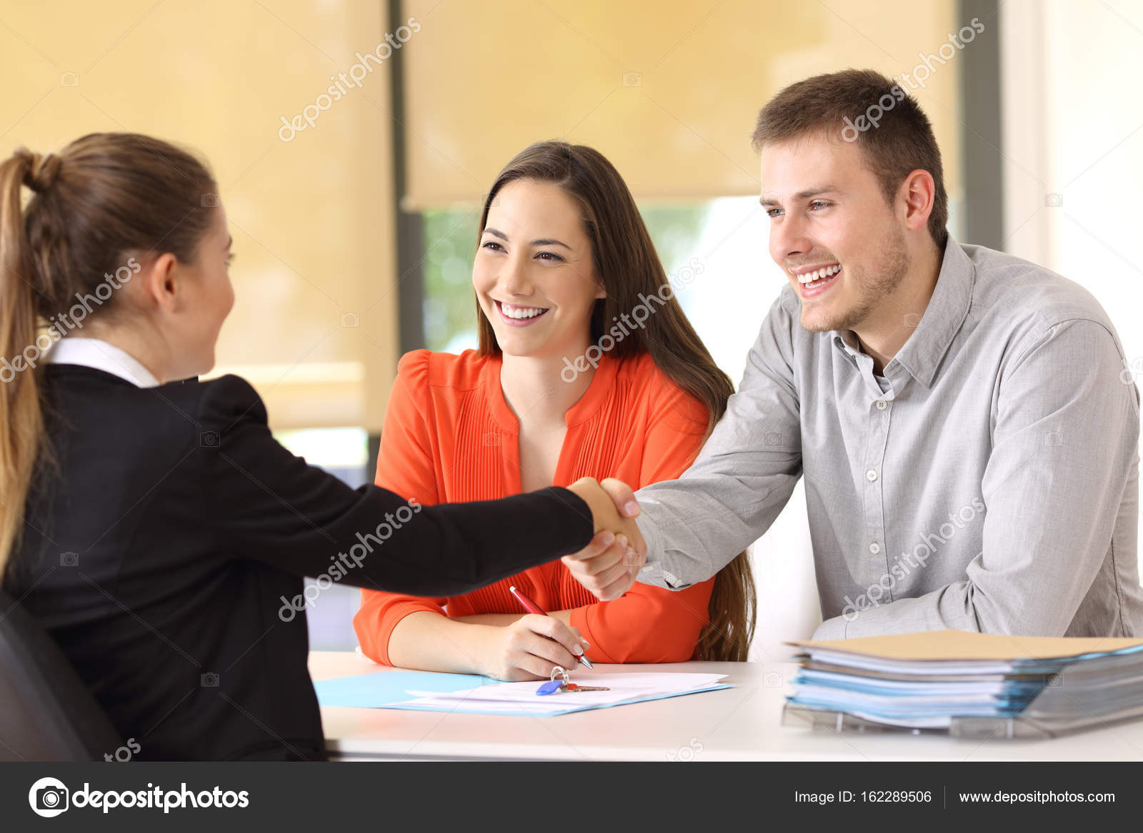 Happy customers handshaking after a deal Stock Photo by ...