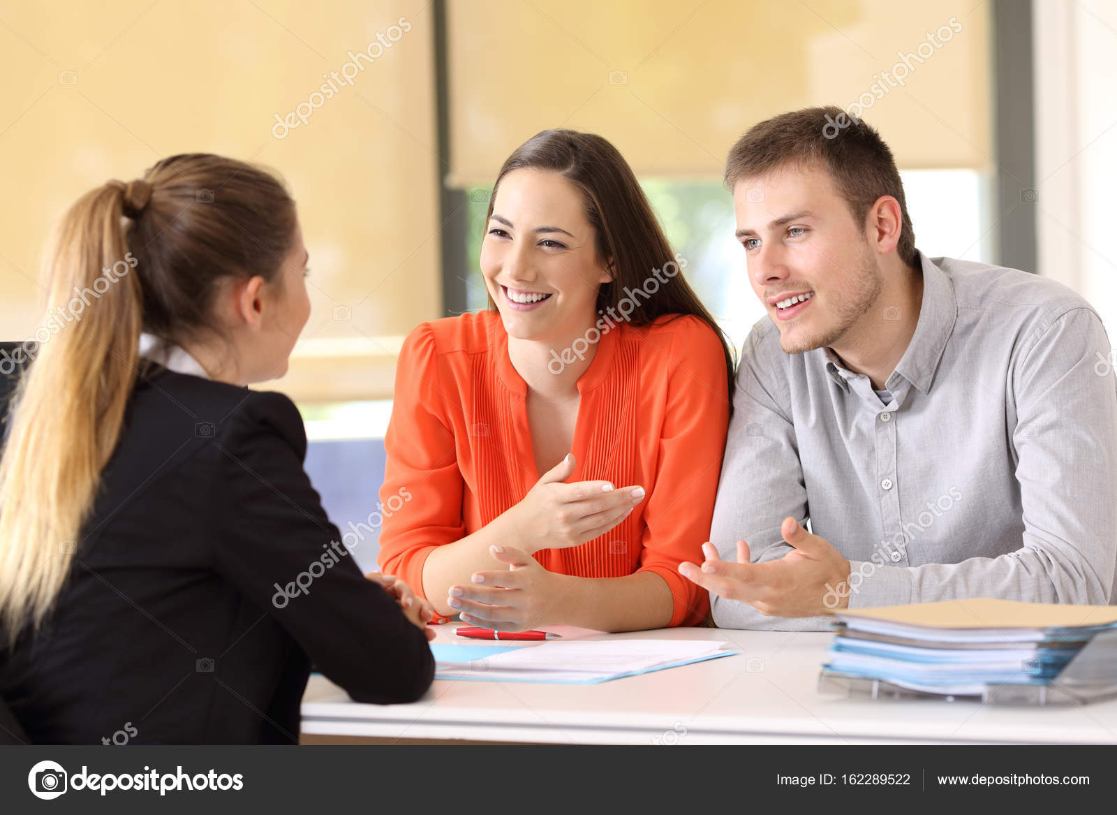 Happy customers talking with office worker — Stock Photo ...