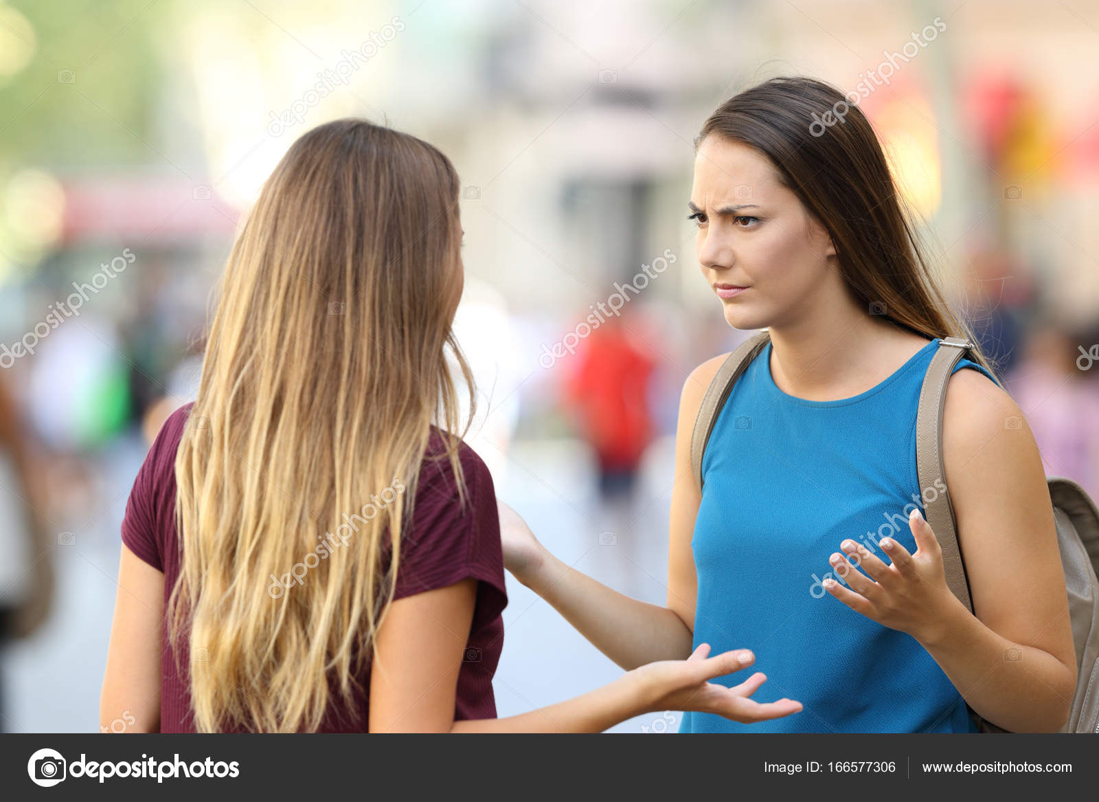 Angry friends having a serious conversation outdoors Stock Photo by ...