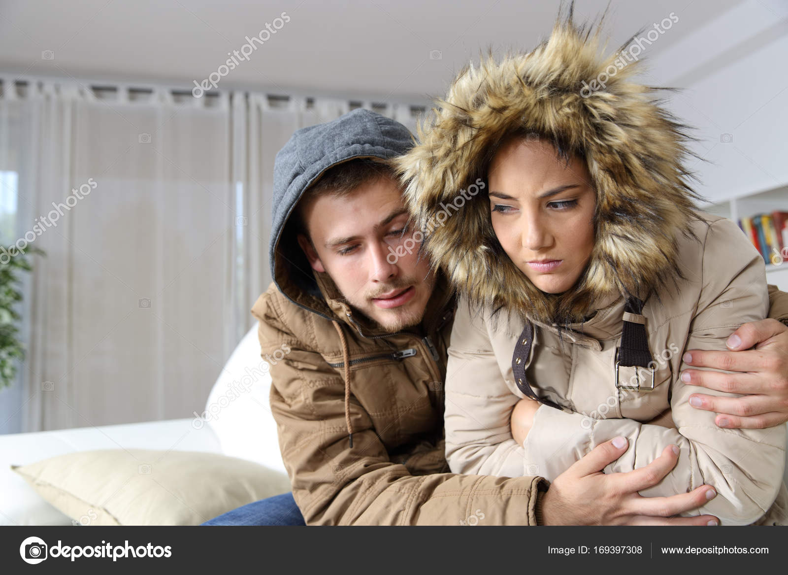 Cold home with an angry couple Stock Photo by ©AntonioGuillemF 169397308