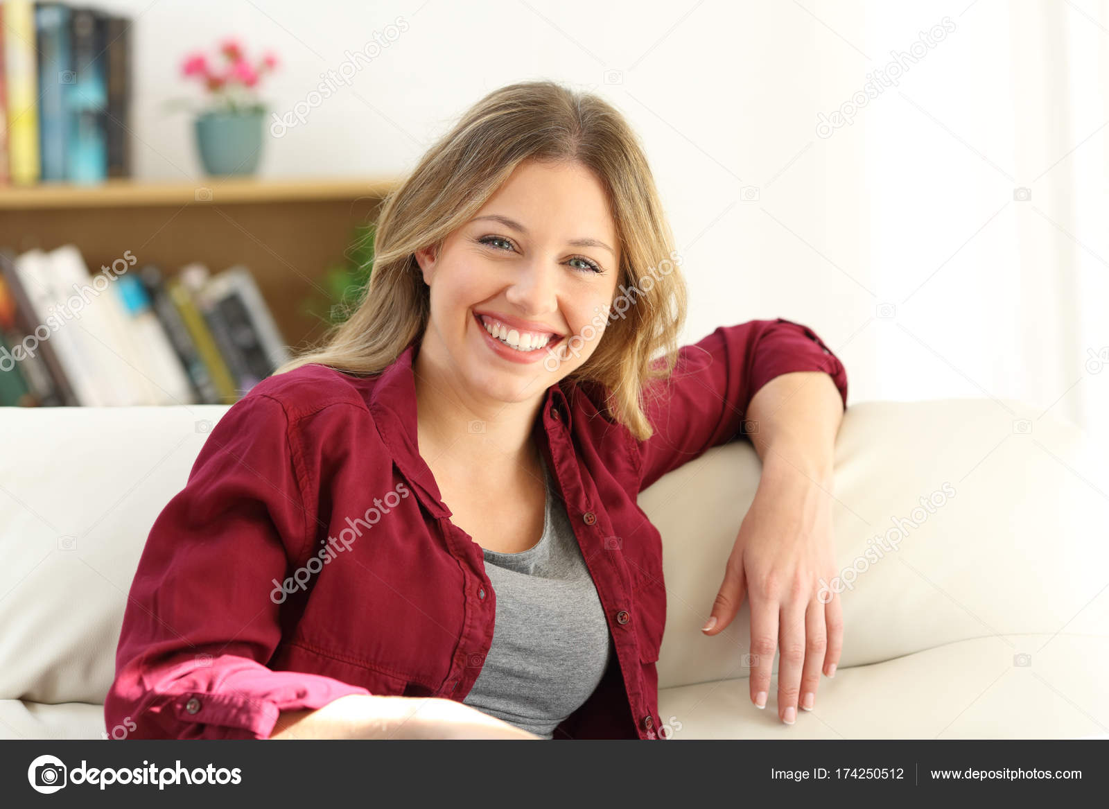 Happy home owner posing on a couch Stock Photo by ©AntonioGuillemF ...