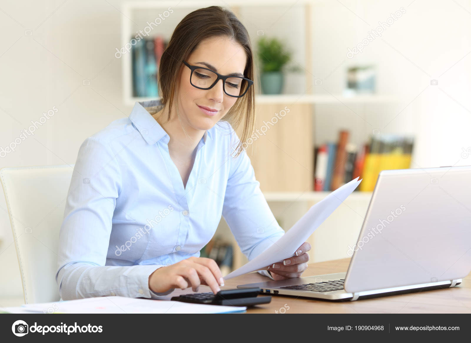 Woman calculating with a calculator at home — Stock Photo ...
