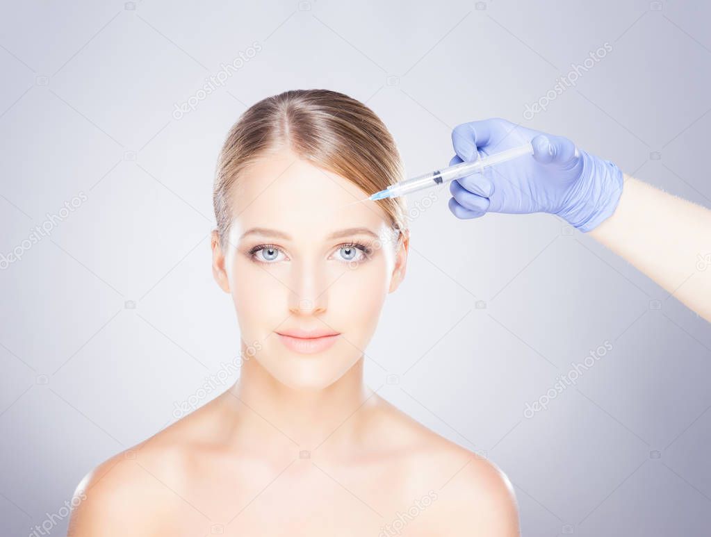 Doctor making injection into face of woman — Stock Photo © shmeljov ...